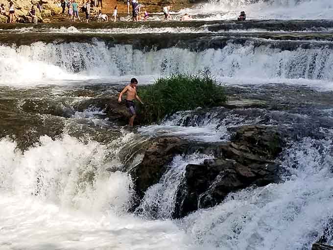 That brave soul perched on the rock proves some people have more courage than common sense.