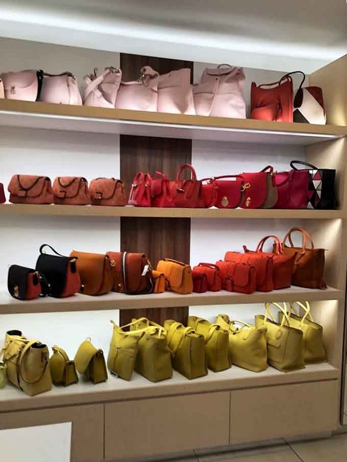 When handbags are organized by color like a leather rainbow, choosing just one becomes delightfully impossible for any shopper.