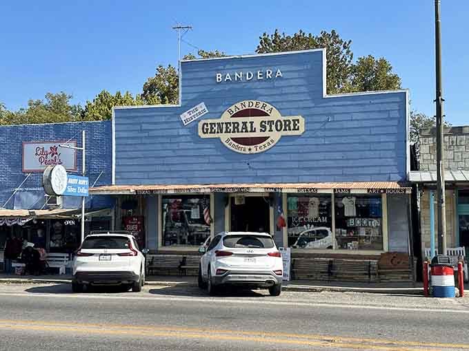 The weathered blue facade stands proud on Main Street, promising cowboy boots, cold treats, and genuine hospitality inside.