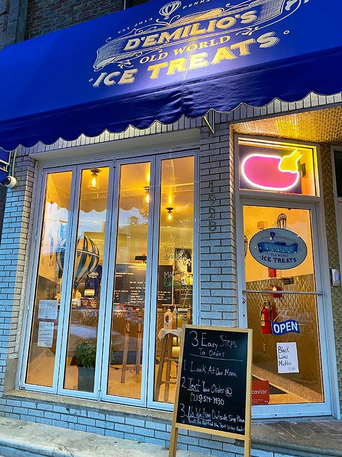 The royal blue awning glows like a welcoming beacon, promising old-world Italian ice cream traditions inside.