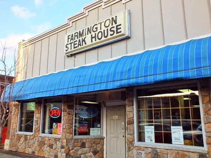 That bright blue awning and stone facade signal small-town charm with big-city flavor waiting inside for you.