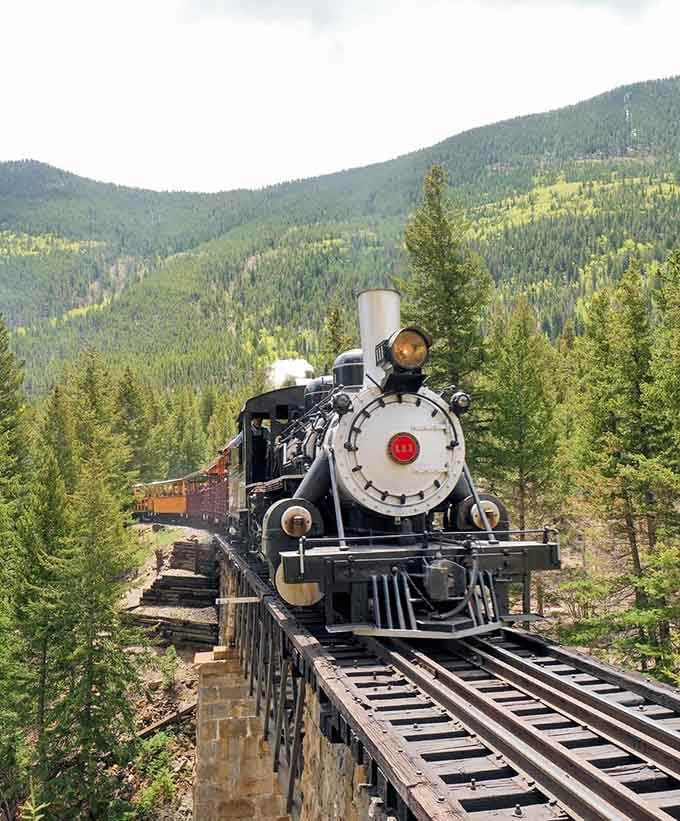 That classic steam engine crosses a wooden trestle bridge high above the forest, making your heart skip just a beat.