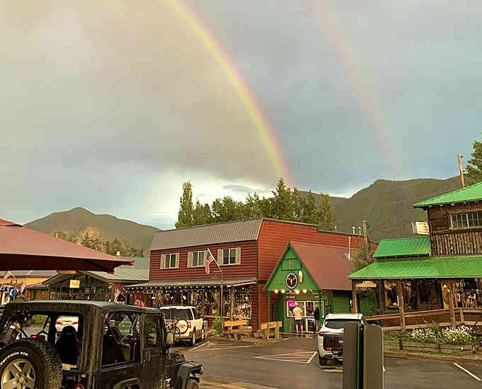 Double rainbows over mountain towns are nature's way of saying you've arrived somewhere truly special and worth the drive.
