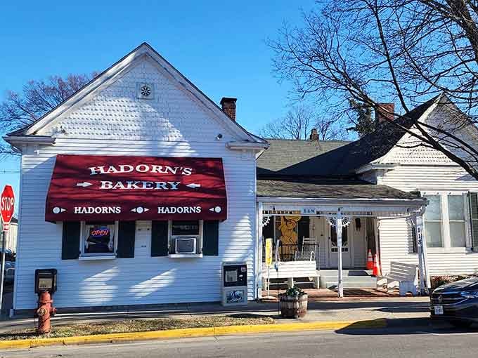 This charming white cottage with its cheerful red awning could easily be mistaken for grandma's house, but better.