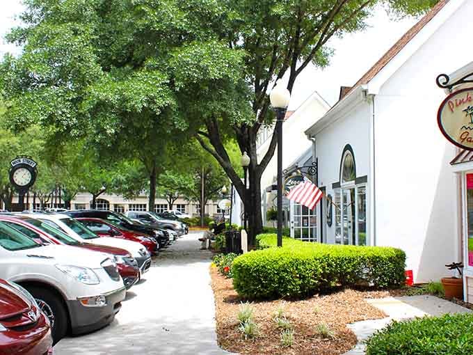 Shaded sidewalks and white storefronts create the kind of shopping district where browsing feels like vacation.