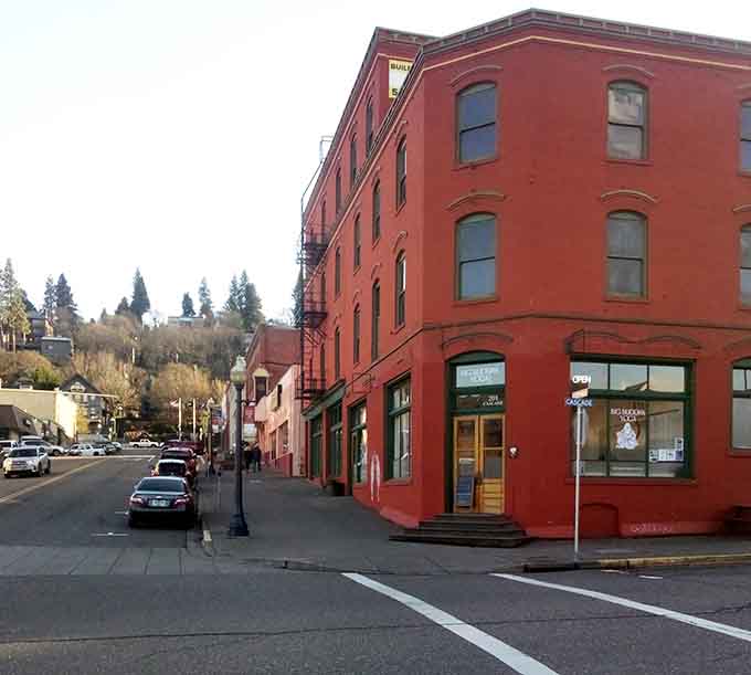 The warm brick tones of this historic building glow against Hood River's evergreen hillside backdrop.