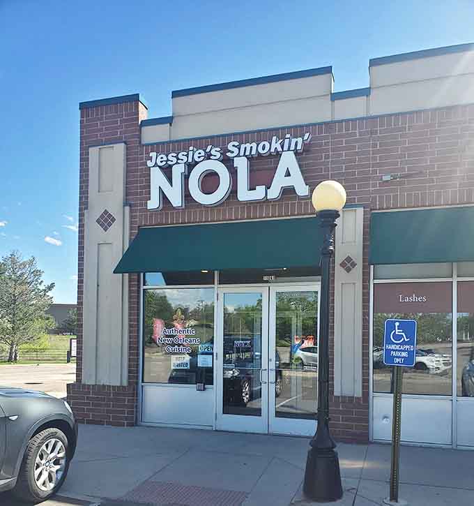 The green awning and crisp brick facade welcome you like a front porch on Bourbon Street.