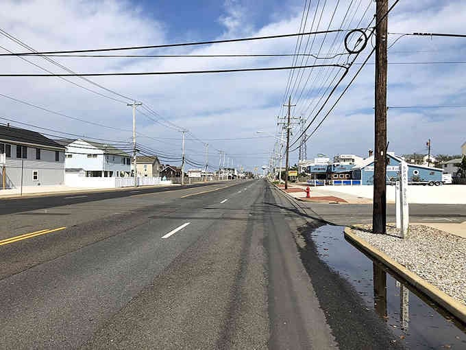 The open road stretches toward endless possibilities, where beach life meets peaceful island living year-round.