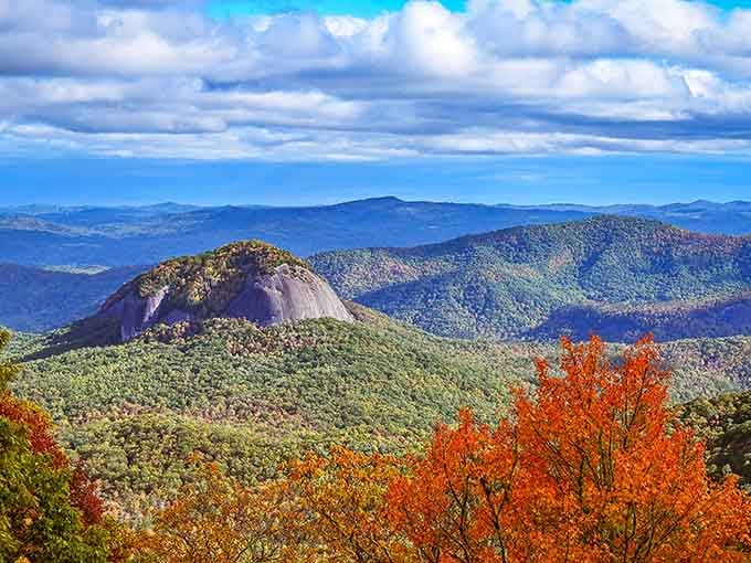 Looking Glass Rock gleaming in autumn's embrace, framed by fiery foliage that would make any postcard jealous beyond belief.