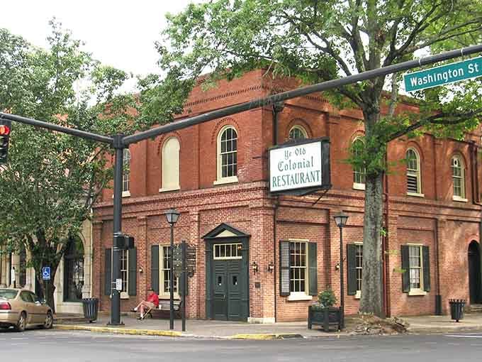 Historic brick architecture shaded by ancient oaks whispers stories from generations past with quiet dignity.