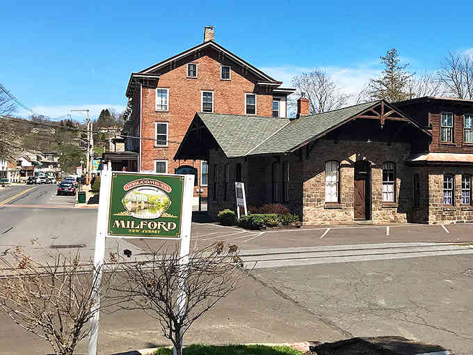That riverside mill building stands like a monument to craftsmanship, reflecting perfectly in waters that have flowed for centuries.