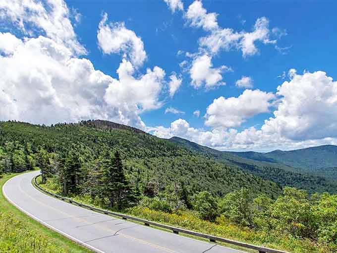 Summer clouds tower above green mountains, making every mile feel like driving through a postcard.