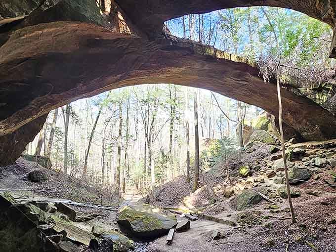 Standing beneath this ancient stone arch feels like discovering nature's own cathedral hidden in the forest.