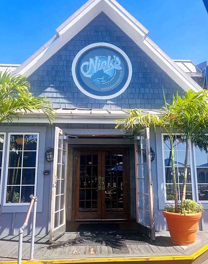 The nautical blue exterior catches the midday sun, promising dock-fresh catches just beyond those inviting wooden doors.