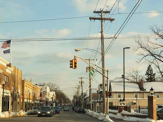 Winter's sky cools over main street where traffic lights sway and local shops wait with warm welcomes.