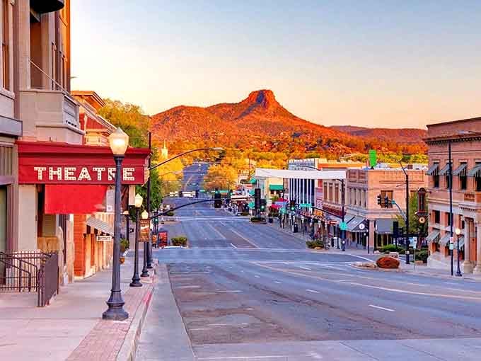 Golden hour bathes the historic theater and mountain backdrop in light that photographers dream about capturing.