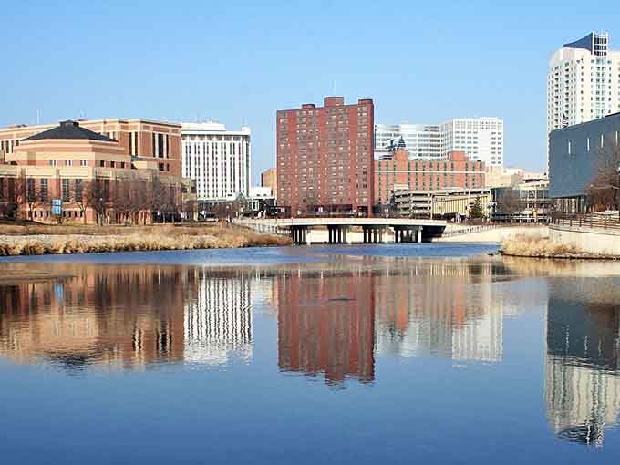 Rochester's skyline reflects perfectly in the water, creating a mirror image that would make Ansel Adams reach for his camera.
