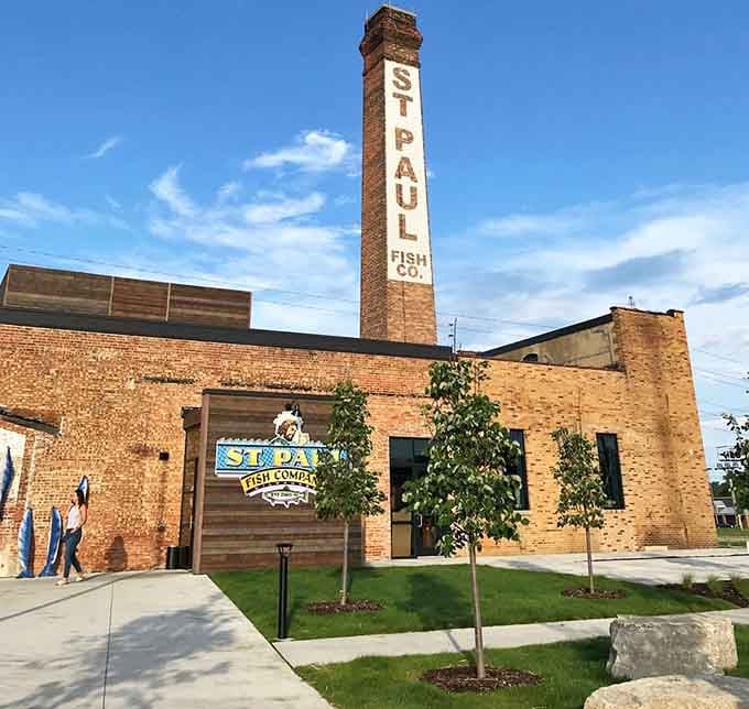 That towering brick smokestack stands like a monument to Milwaukee's industrial past, now serving up fresh catches daily.