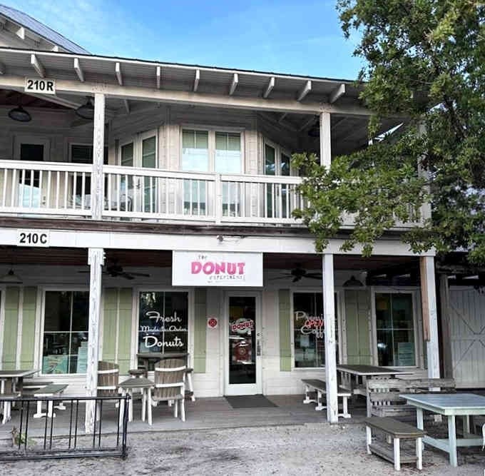 This beachy two-story building with white railings proves the best donuts come from places that look like vacation cottages.