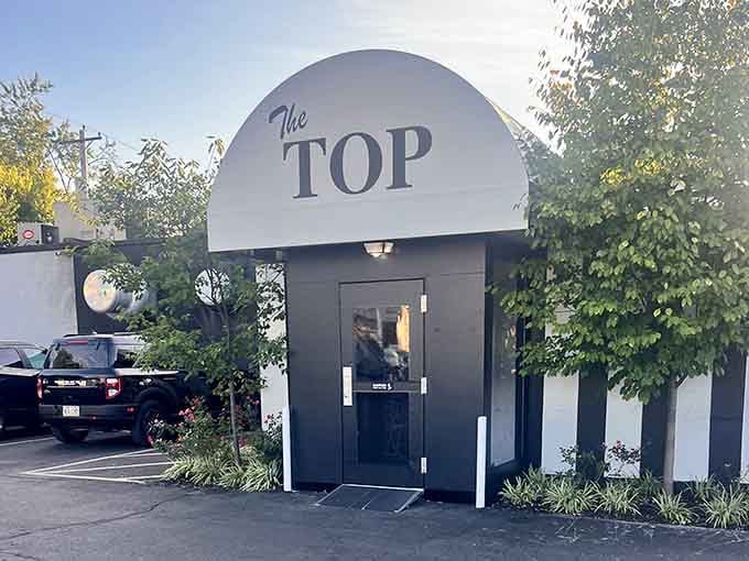 That curved entrance isn't just architecture&mdash;it's a portal to decades of perfectly grilled tradition and flavor.