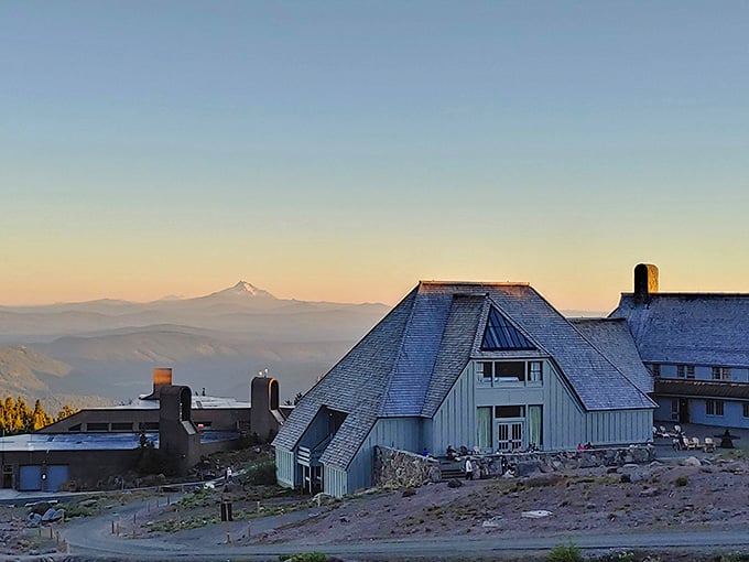 Sunrise paints Timberline Lodge golden while Mount Hood watches over this mountain masterpiece from the 1930s.