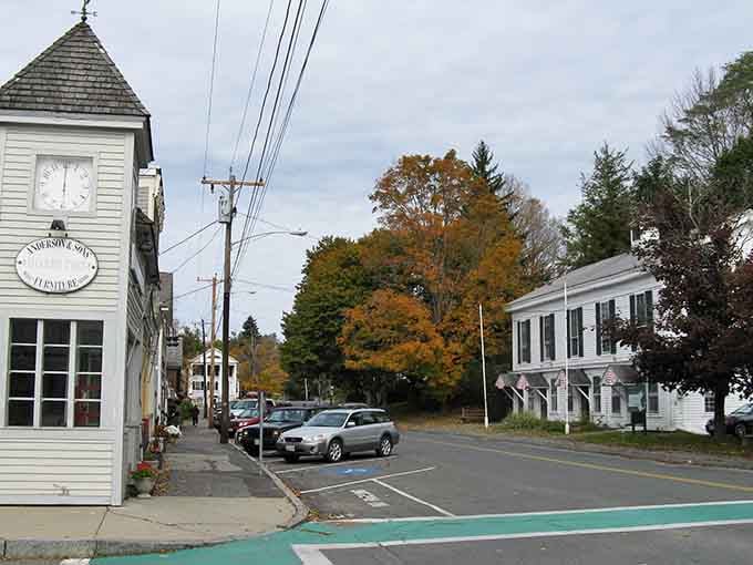 That charming clock tower marks time in a town where autumn leaves actually outnumber the traffic lights.