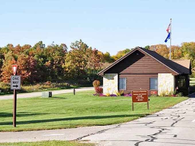 The park entrance sits quietly among autumn colors, inviting you to explore trails where nature does all the talking.