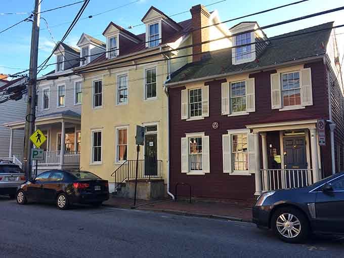 Colonial-era townhouses line the narrow streets, their painted facades glowing warmly in the afternoon sun.