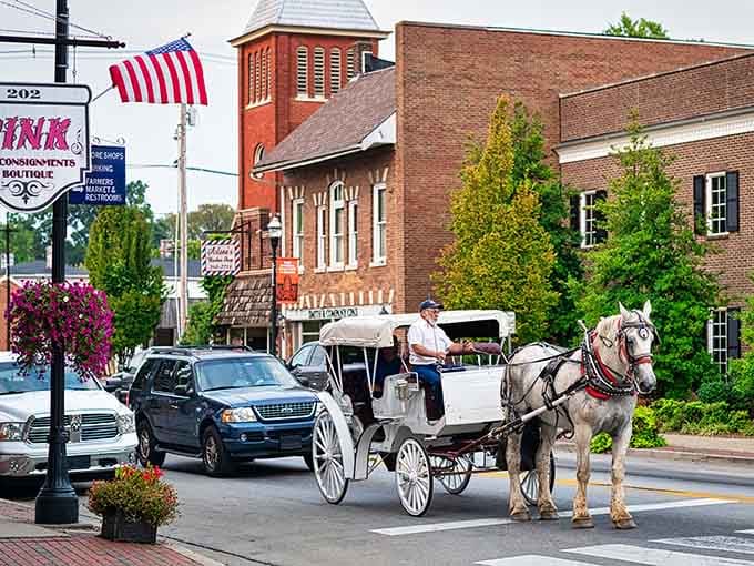 That horse-drawn carriage rolling past historic shops proves some traditions never go out of style.