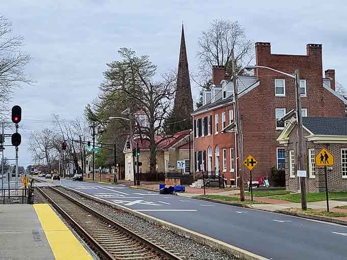 That church steeple rising above the railroad tracks creates a skyline that's pure small-town American charm.