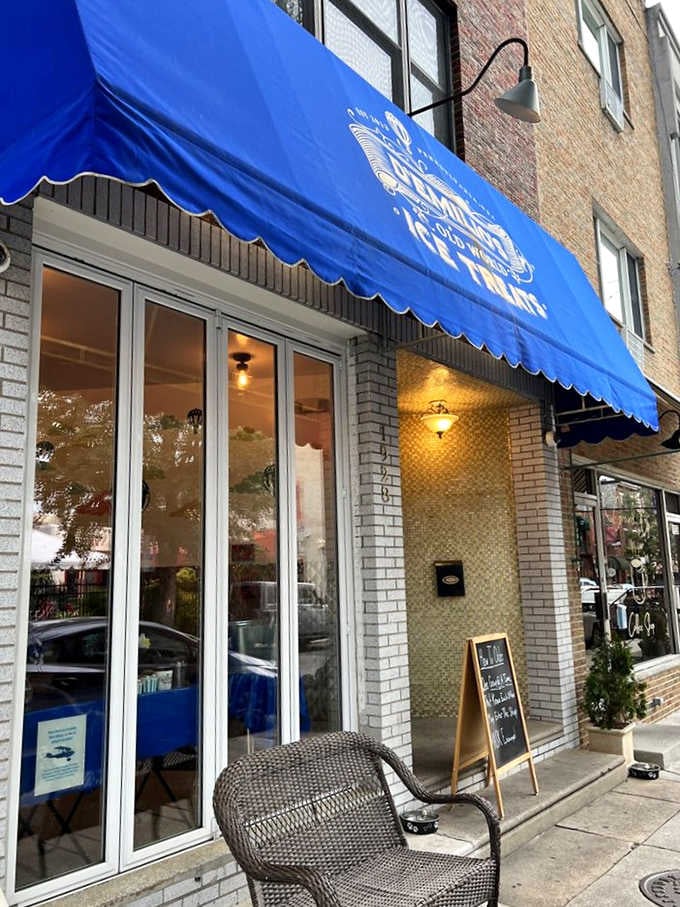 White brick and warm lighting create an inviting entrance where European-style treats meet Philadelphia's vibrant street life.