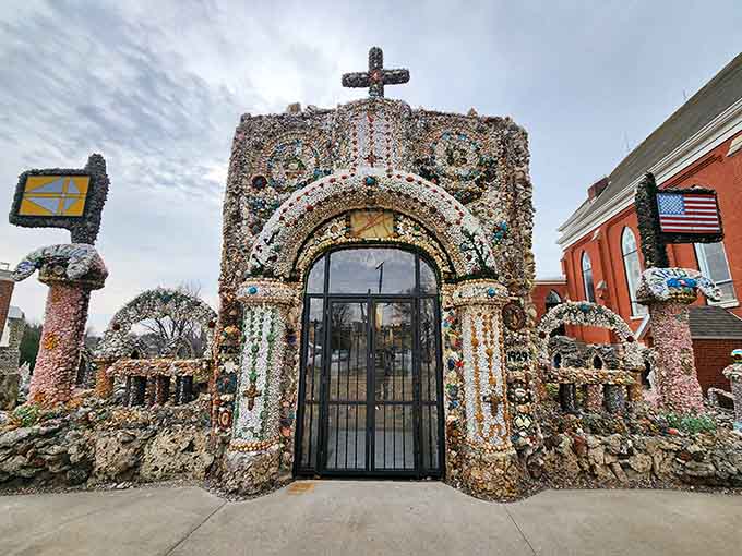 The intricate stone archway entrance welcomes visitors into a world where every surface tells a sparkling story.
