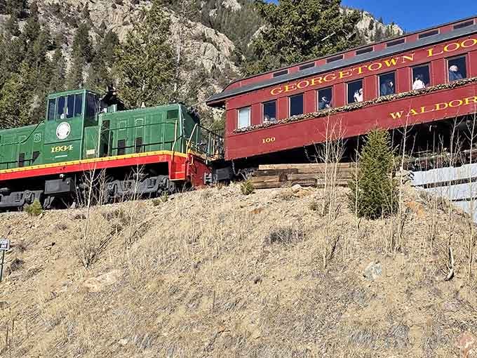 The Georgetown Loop's vintage passenger car hugs the rocky canyon wall, offering views that'll make you forget your fear of heights.