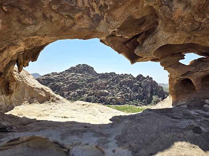 Peering through this natural window carved by wind and water reveals a view that makes every step up here worthwhile.