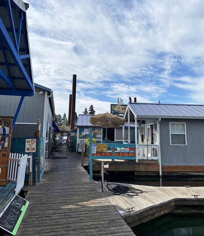 Wooden boardwalks wind between floating cottages where fresh breezes and island vibes make every visit feel like vacation.