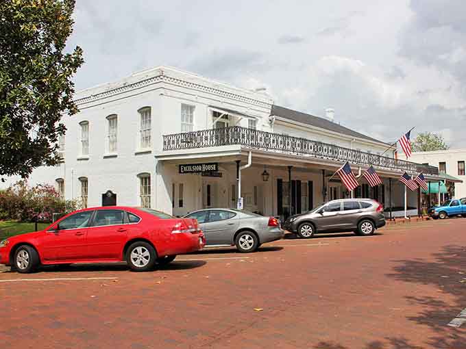 The Excelsior House stands proud with its flags flying, looking exactly like it did when stagecoaches rolled through town.