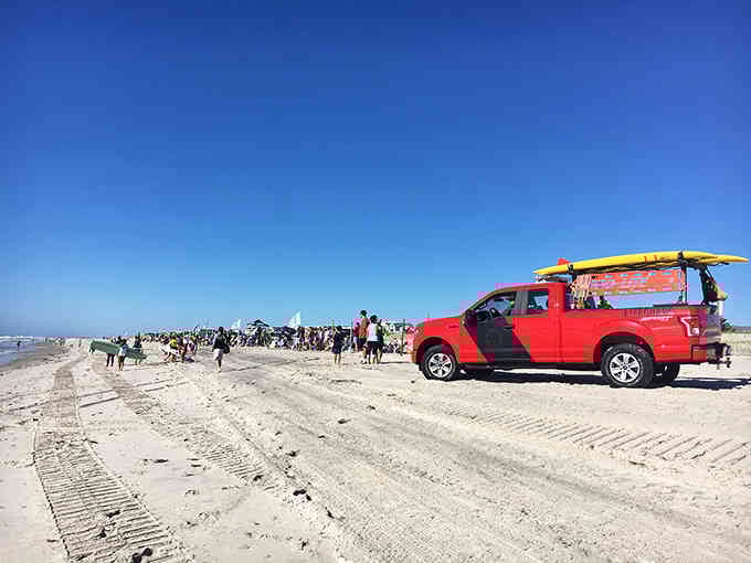 Perfect beach weather brings crowds to the sand, where that red truck knows the best spot to park.