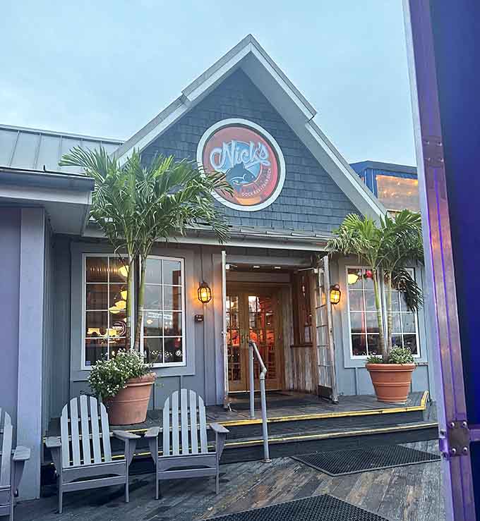 Dusk transforms this dockside gem into a glowing beacon, where lantern light dances across weathered wood and potted greenery.