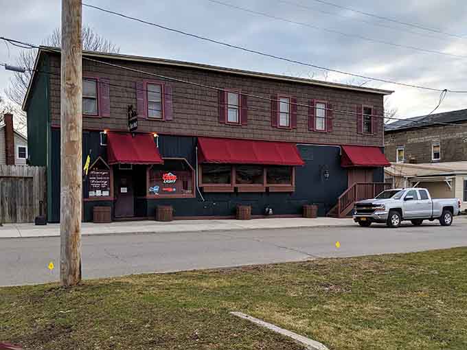 Even on a cloudy day, those welcoming red awnings promise warmth, good food, and the kind of meal worth remembering.