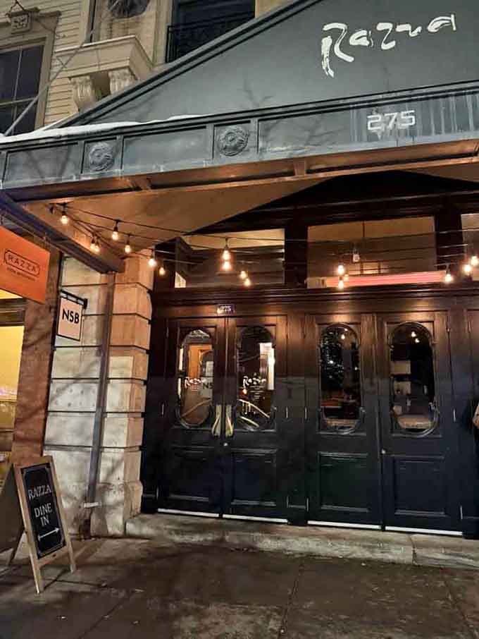 The "RAZZA DINE IN" sign beckons like a friendly invitation to experience what wood-fired pizza was meant to be.