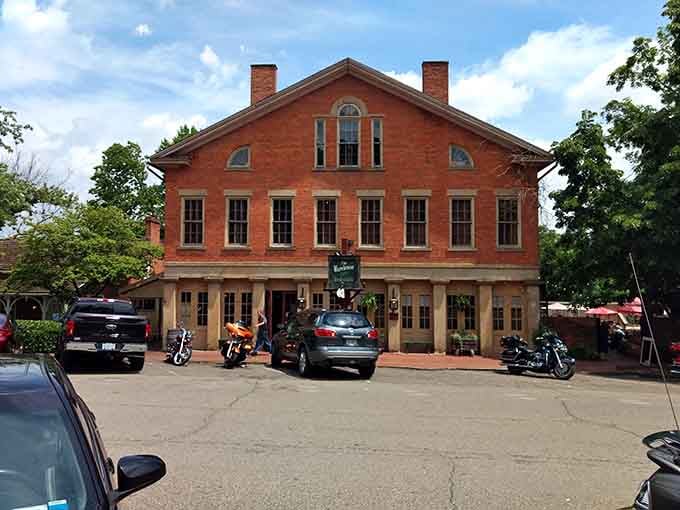 Motorcycles parked outside this stately brick building hint at the timeless appeal of well-preserved 19th-century gathering places.
