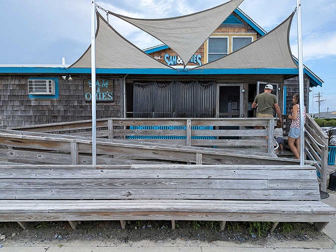The weathered deck and shade sails tell stories of countless meals enjoyed with ocean breezes and sandy toes.