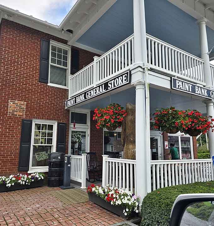Flower baskets cascading from that wraparound porch are basically edible advertising at its most charming.