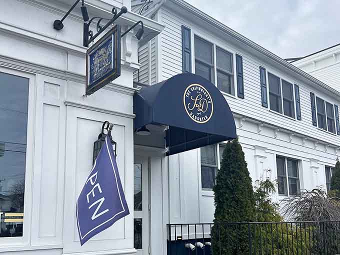 The elegant entrance whispers "come in for oysters" while the purple flag adds a splash of coastal character.