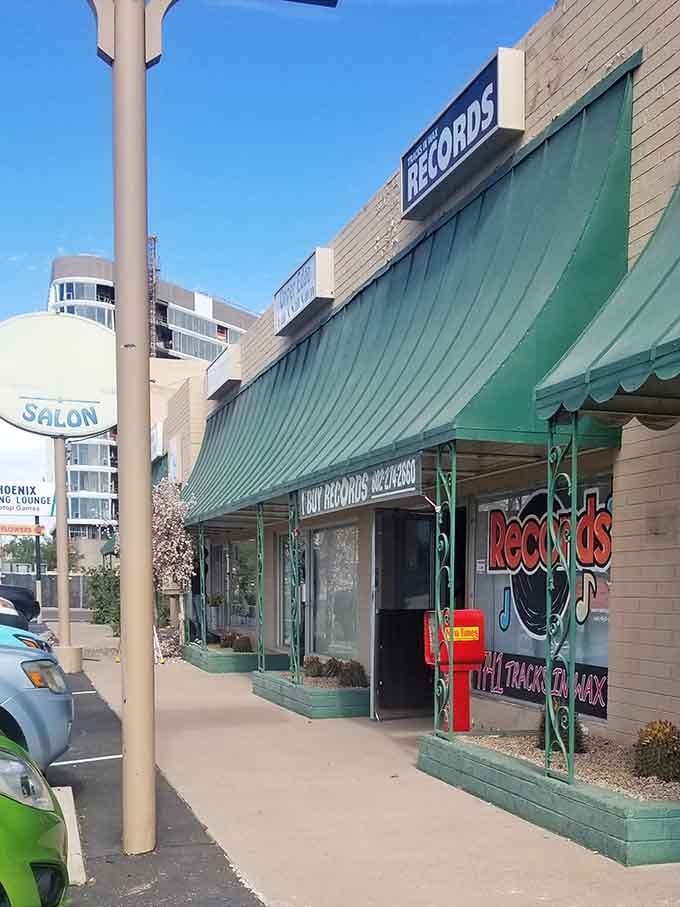 The green awning provides shade for serious record diggers who lose track of time browsing those bins inside.