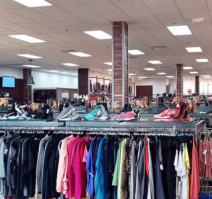 Inside, shoes and sneakers parade across elevated platforms like fashion models strutting their stuff at discount prices.