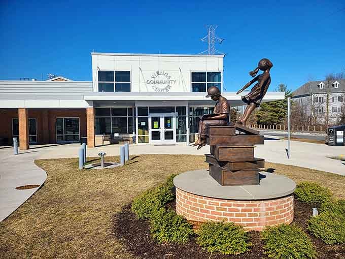That bronze statue celebrates community spirit outside a modern center where neighbors still know each other's names.