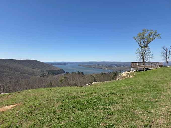 Rolling green hills meet endless blue water in a vista worthy of a postcard collection.