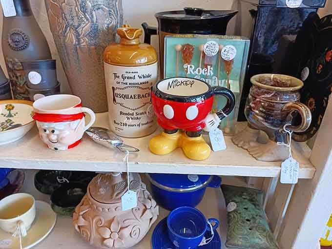 That Mickey Mouse mug is giving serious Disney vault vibes alongside whiskey crocks and retro glassware.