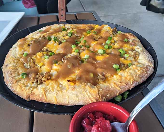 Breakfast pizza topped with gravy and green onions proves that morning creativity knows no bounds here.